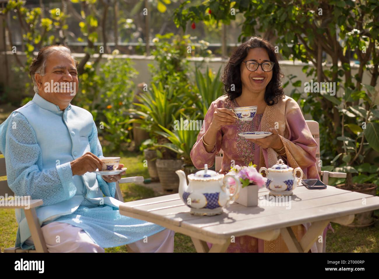 Happy Mature couple having tea together in garden Stock Photo - Alamy