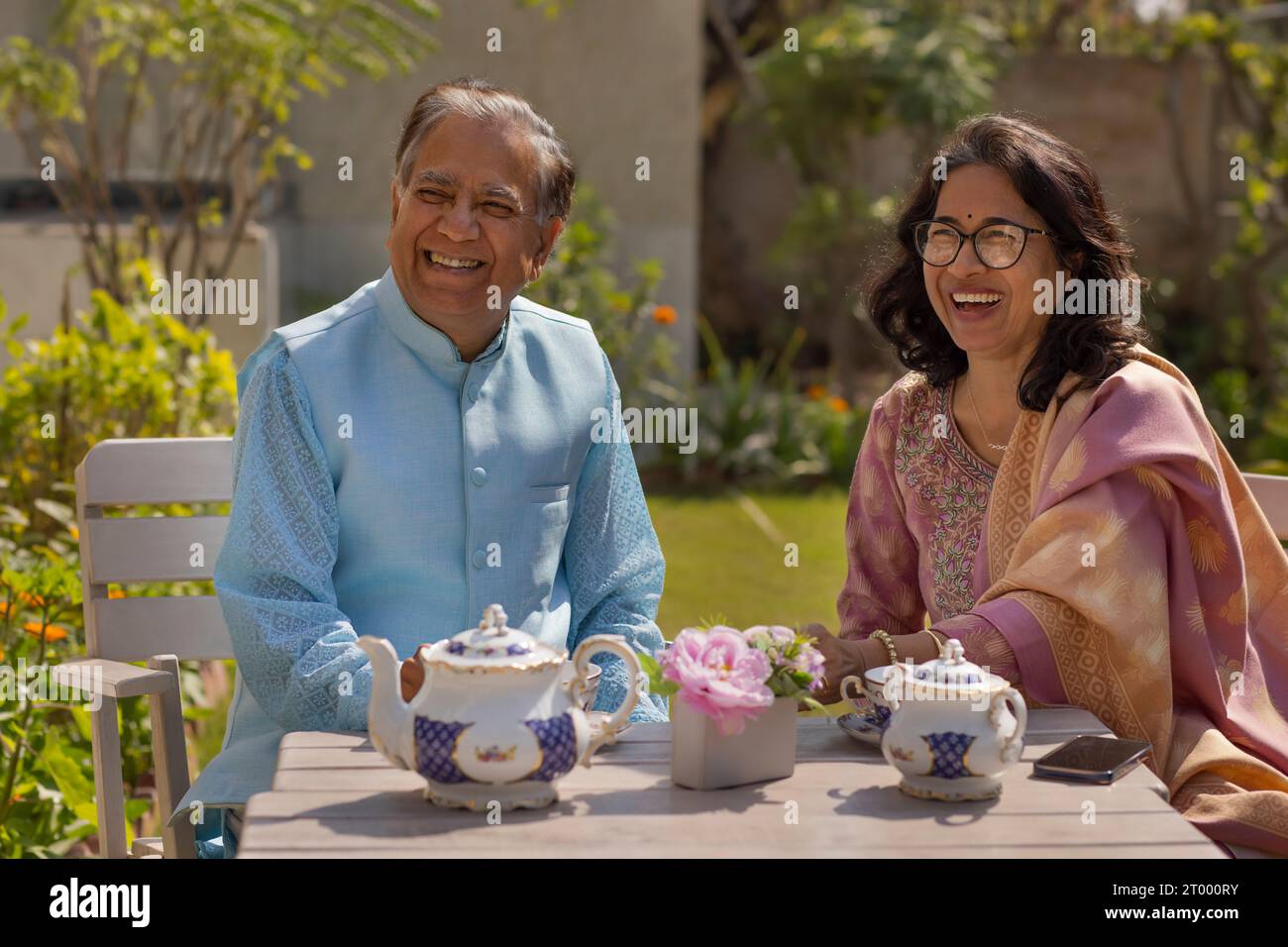 Happy Mature couple having tea together in garden Stock Photo - Alamy