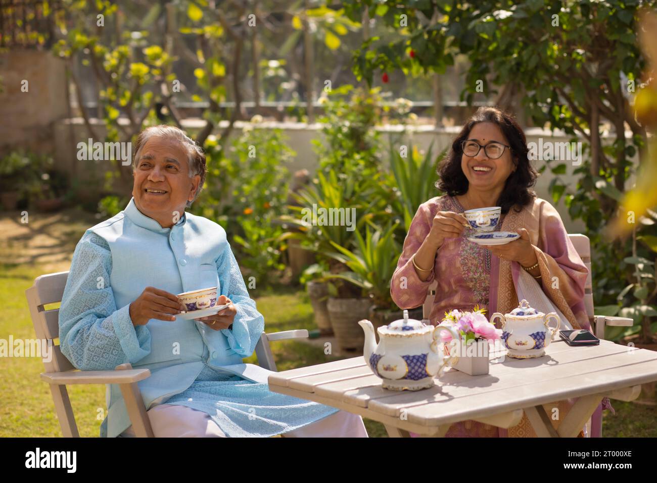 Happy Mature couple having tea together in garden Stock Photo - Alamy