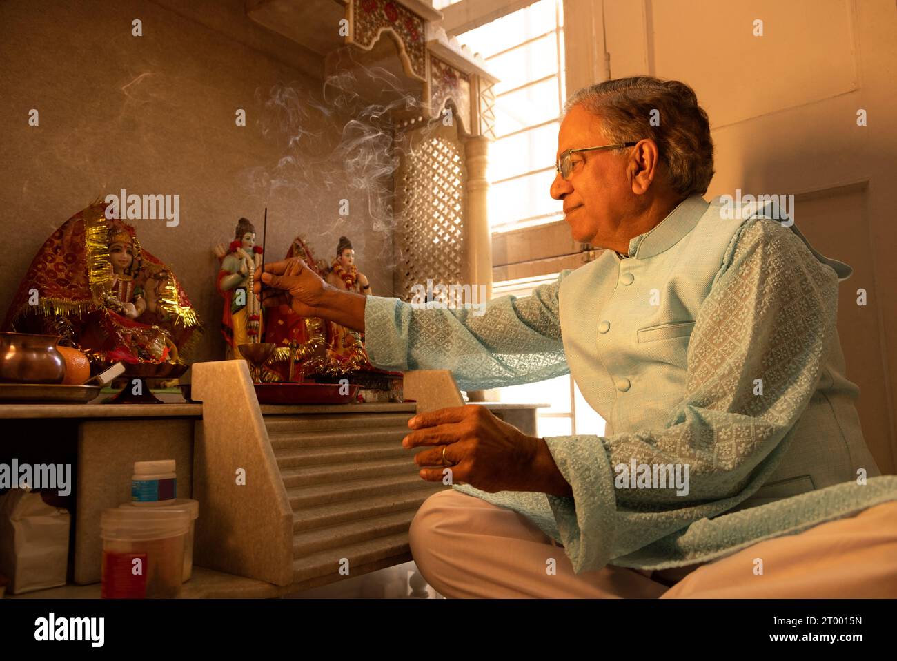 Portrait of senior man performing pooja of Hindu God at home Stock ...
