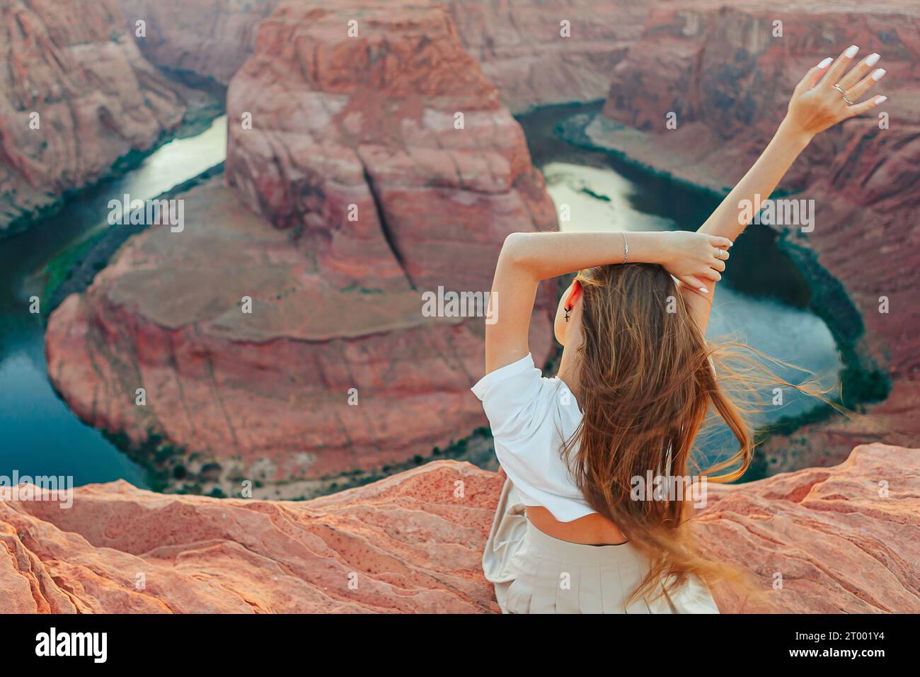 Happy girl on the edge of the cliff at Horseshoe Band Canyon in Page ...