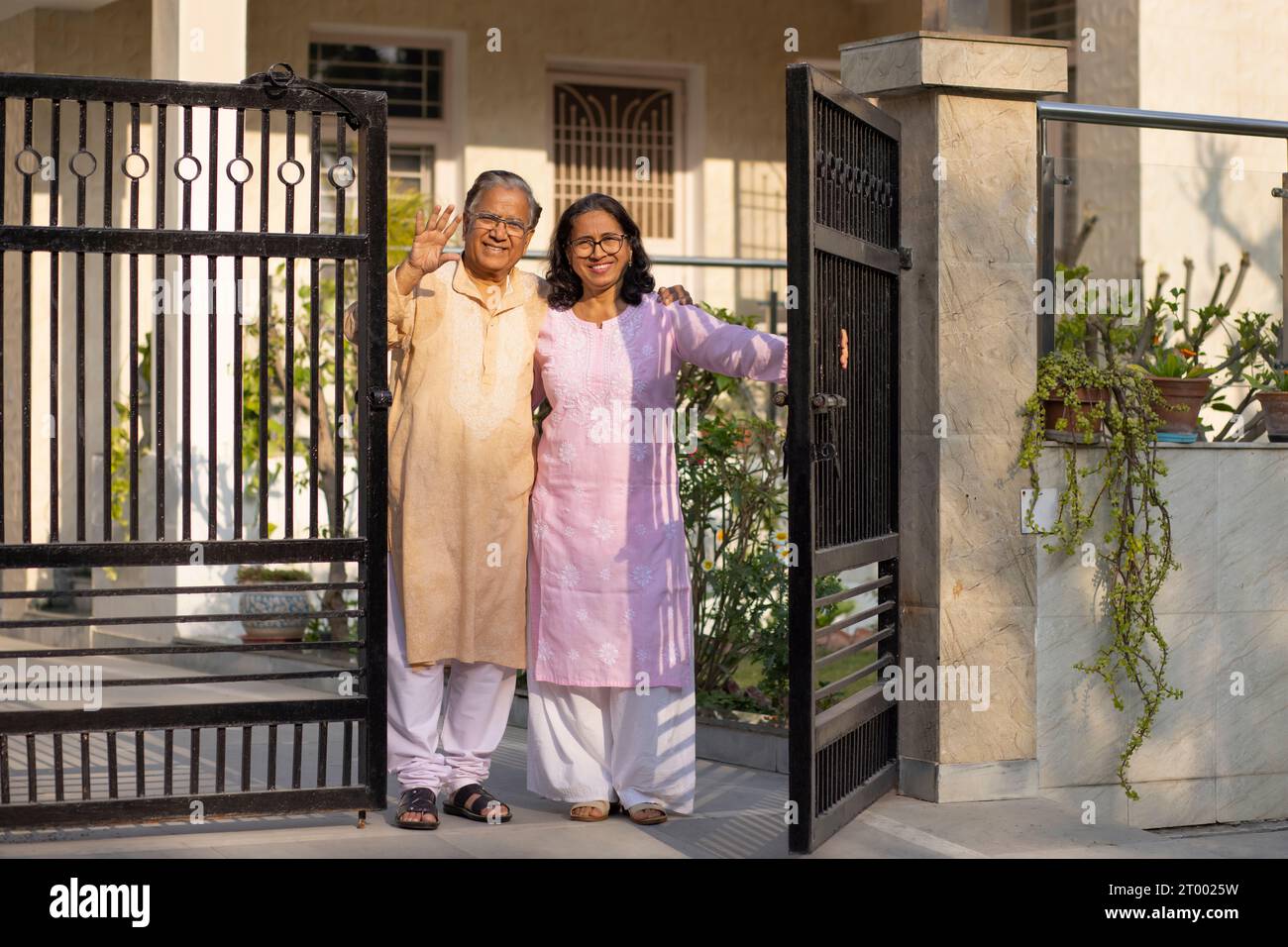Happy Mature couple standing together at gate Stock Photo - Alamy