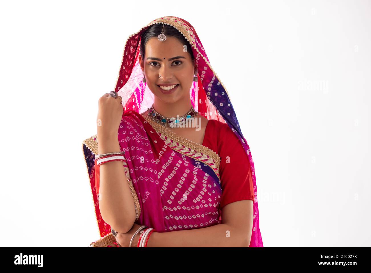 Portrait of Rajasthani woman in sari standing against white background ...
