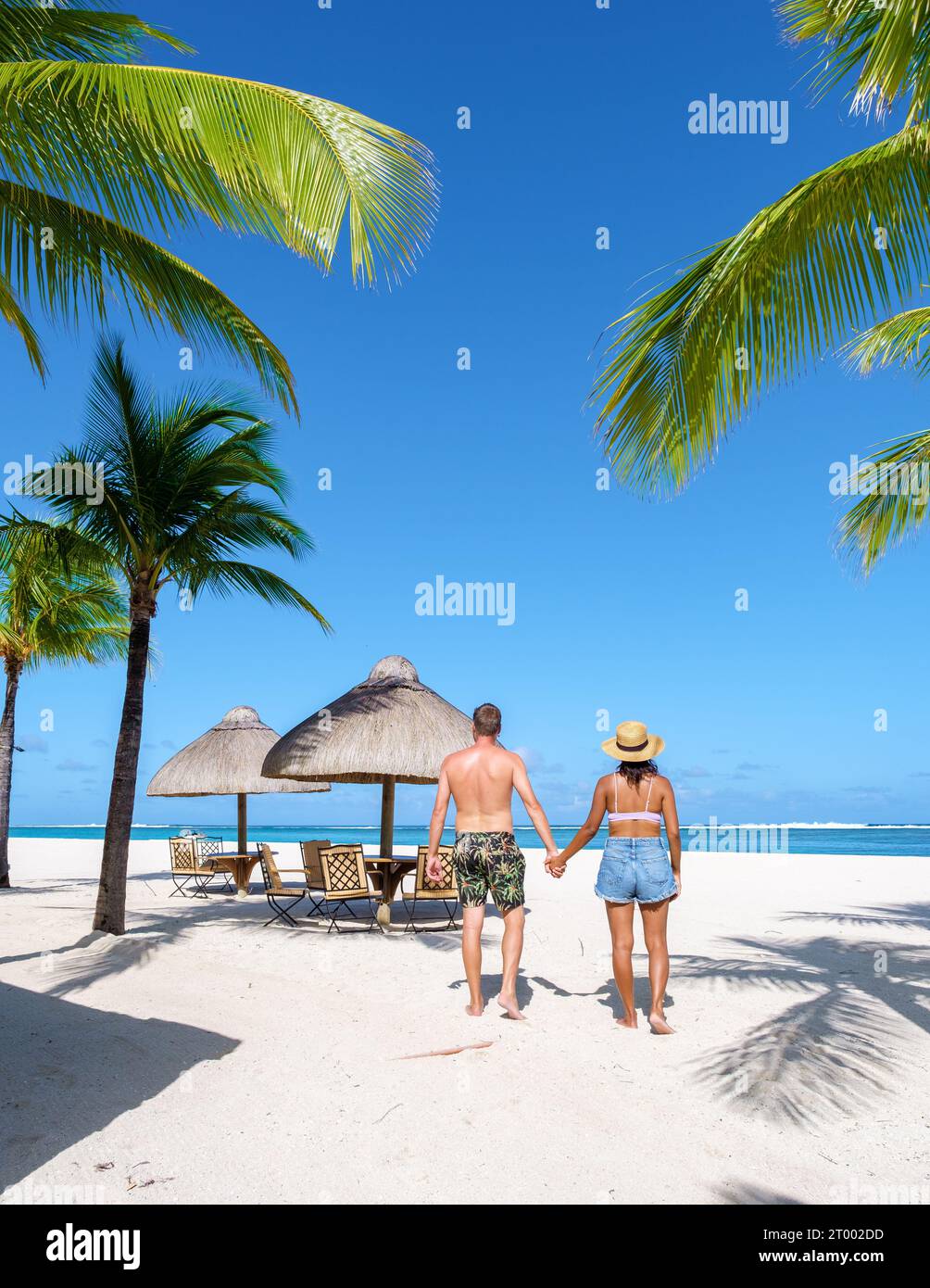 Man and Woman on a tropical beach in Mauritius , a couple on honeymoon ...