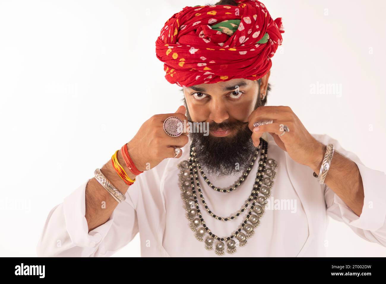 Close-up portrait of Rajasthani young man twisting his moustache ...