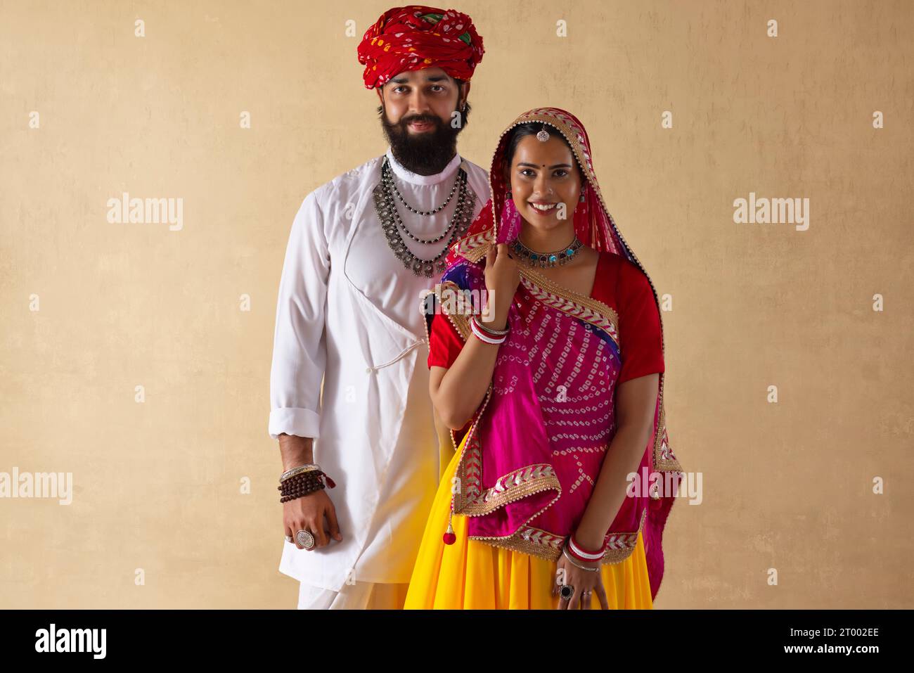 Portrait of Rajasthani couple standing against plain background Stock ...