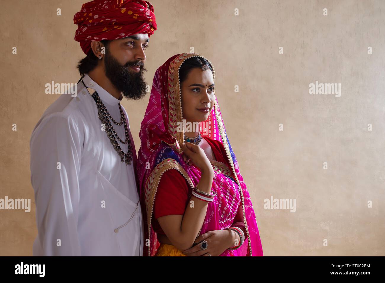 Portrait of Rajasthani couple standing against plain background Stock ...