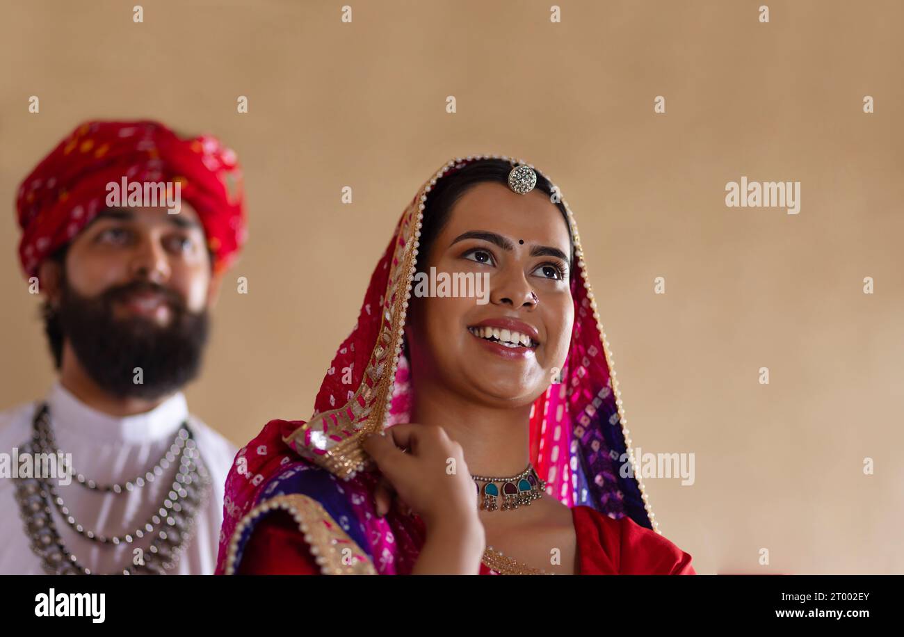 Portrait of Rajasthani couple standing against plain background Stock ...