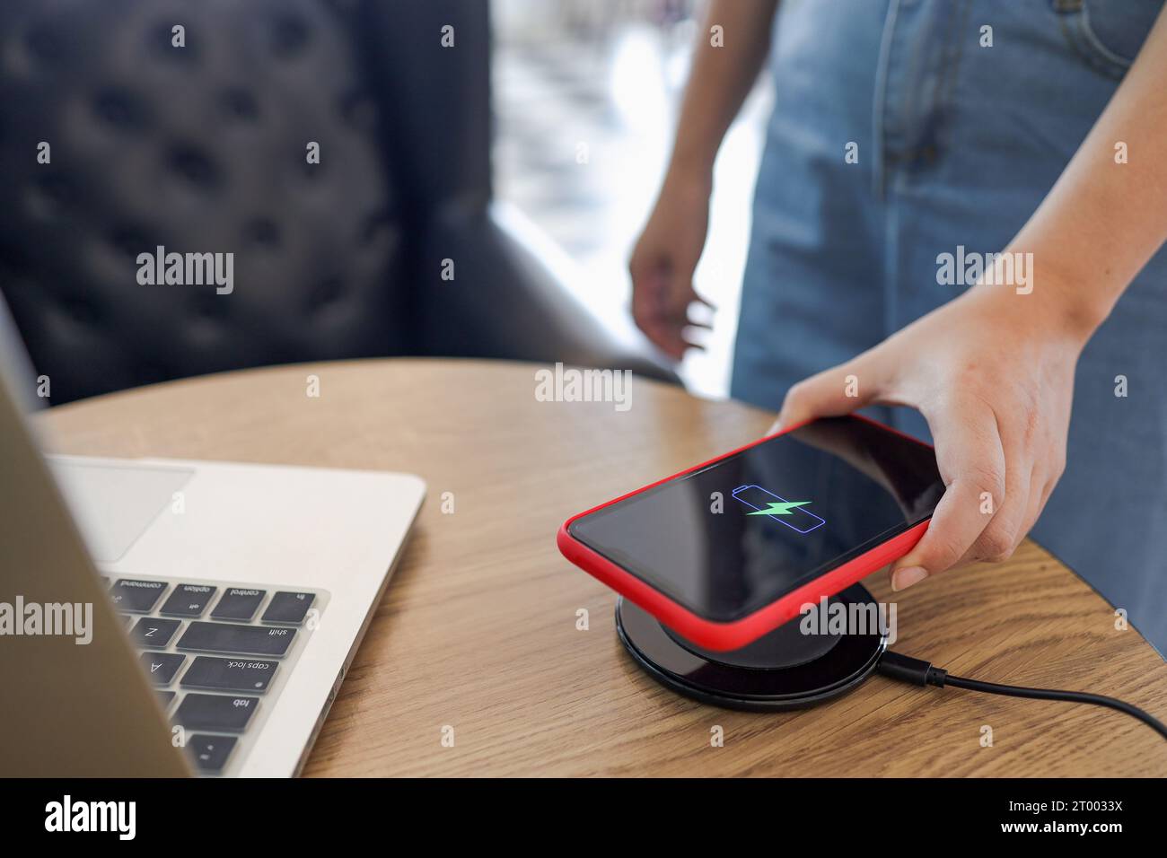 Charging mobile phone battery with wireless device in the table ...