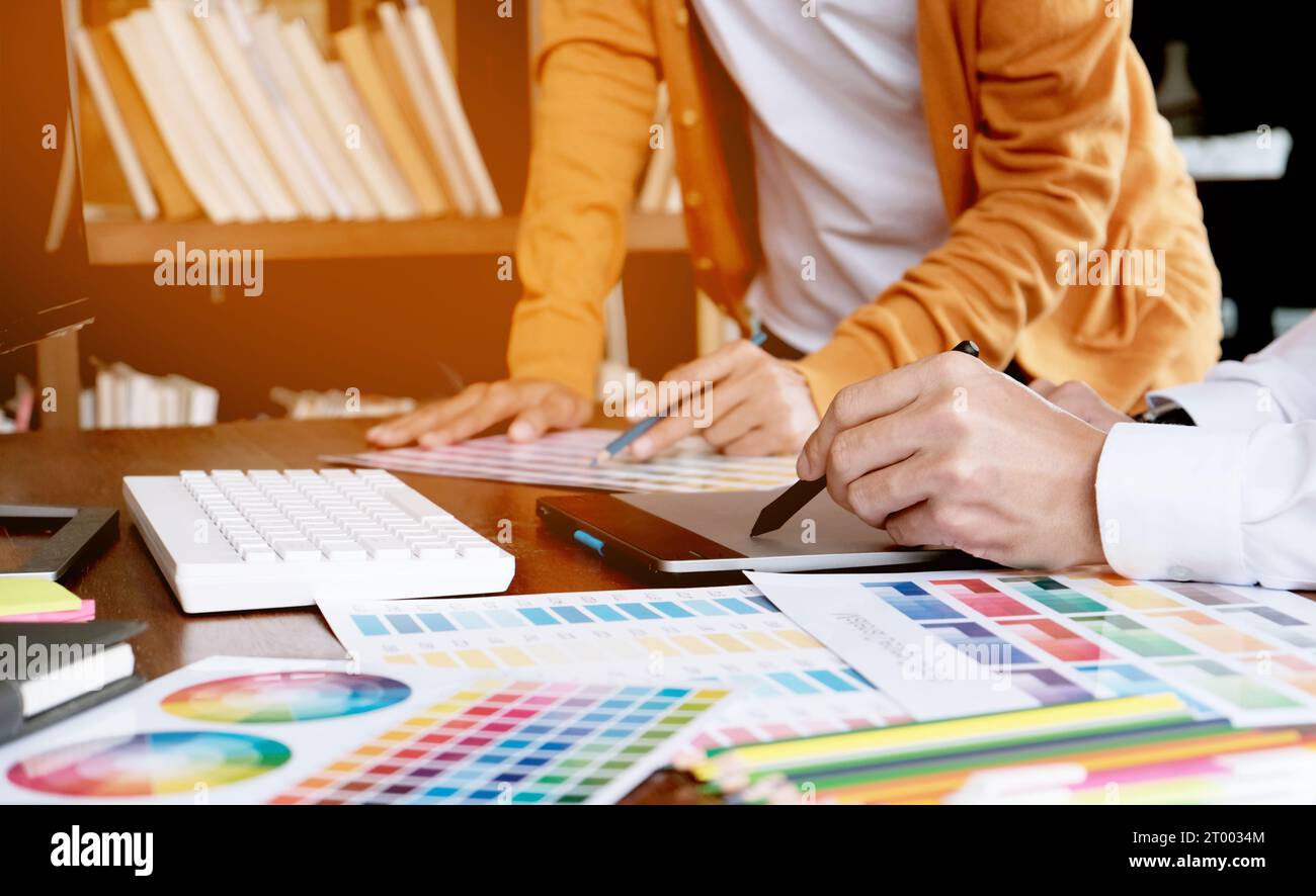 Graphic designer working on digital tablet. artist drawing on graphic tablet and Color swatch ...