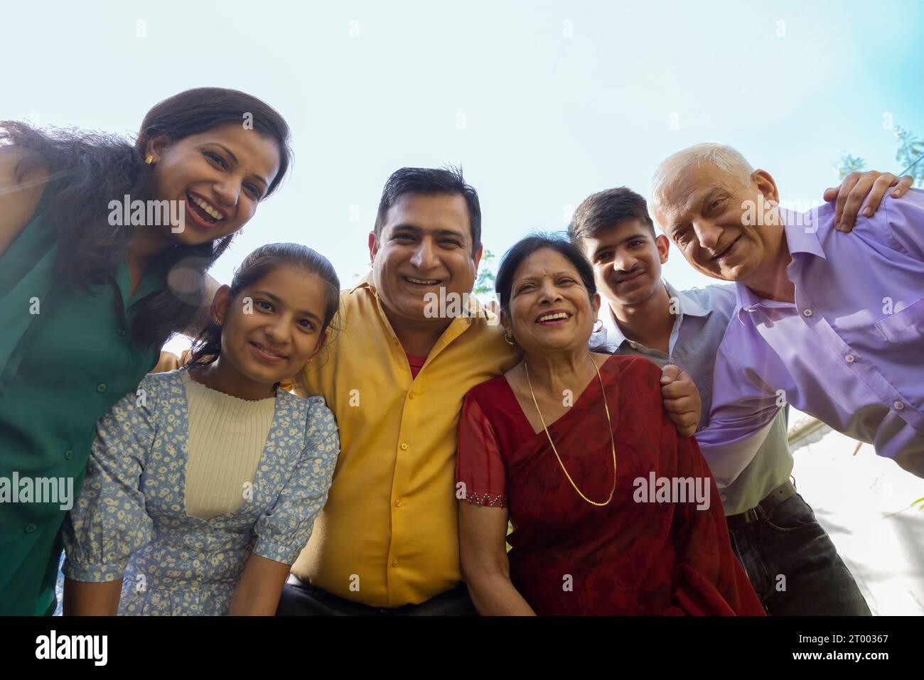 Low angle view of happy multi generation Indian family standing ...
