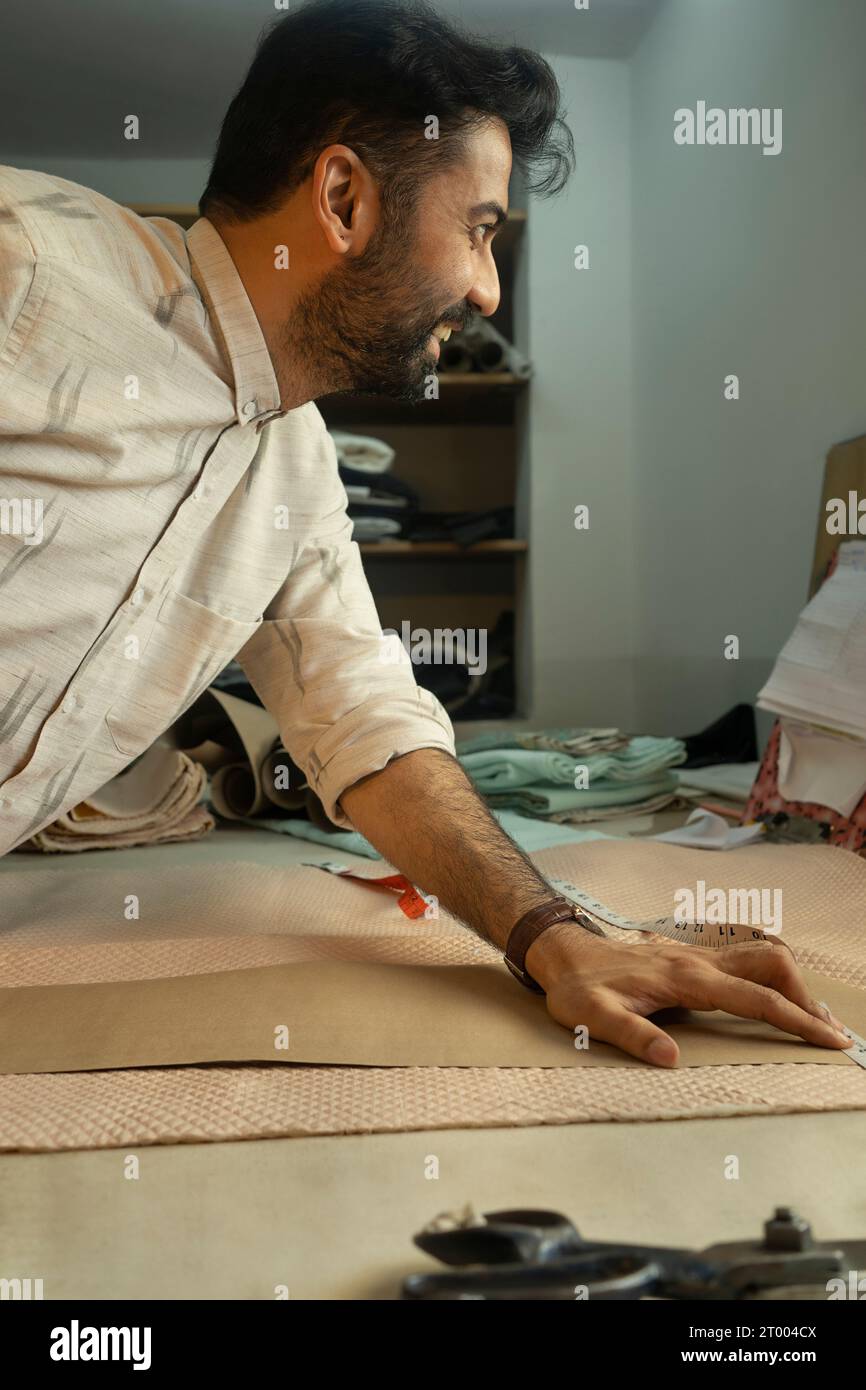 Fashion designer tracing patterns on the cloth Stock Photo - Alamy