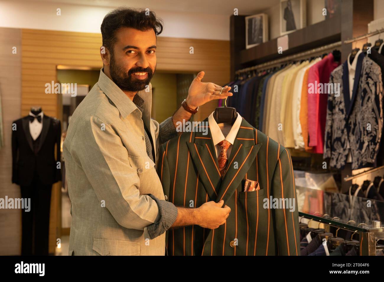 Buyer shopping formal jackets in a bespoke clothing store Stock Photo ...