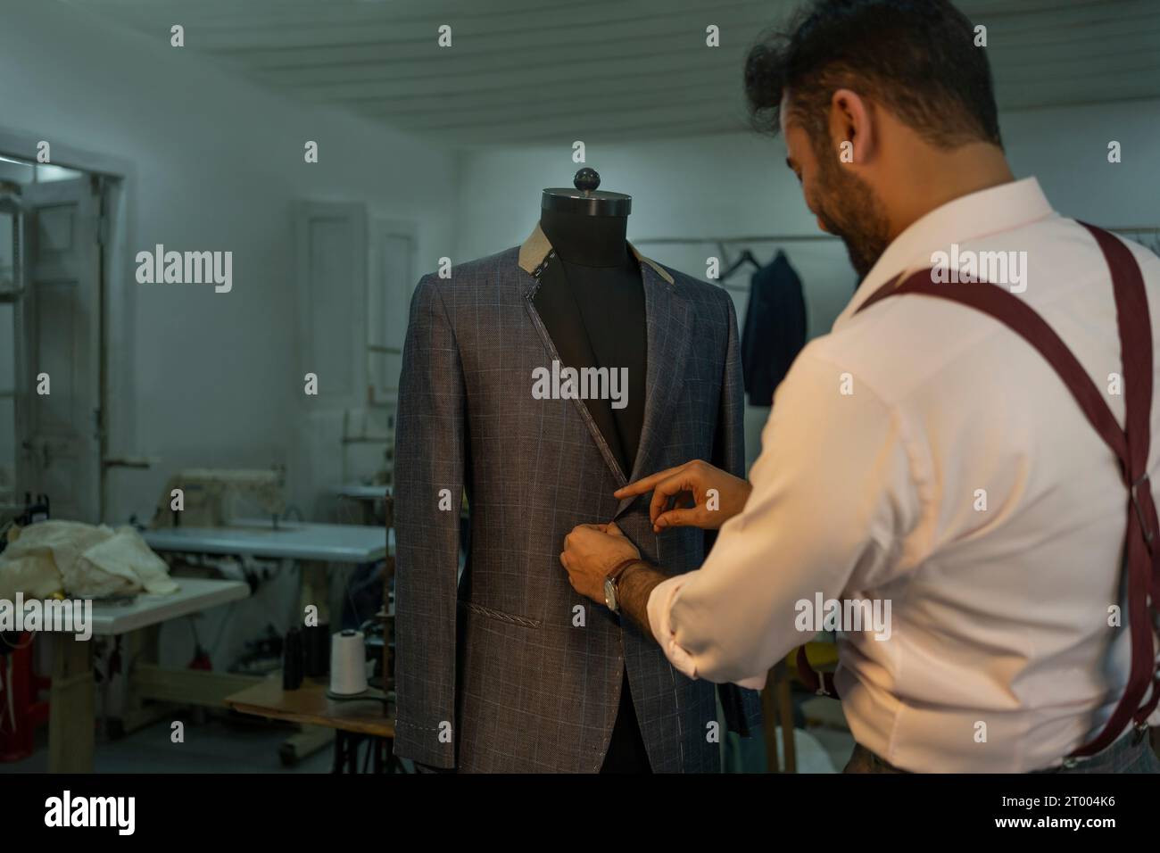 A bespoke tailor checking measurements on a dress form Stock Photo - Alamy