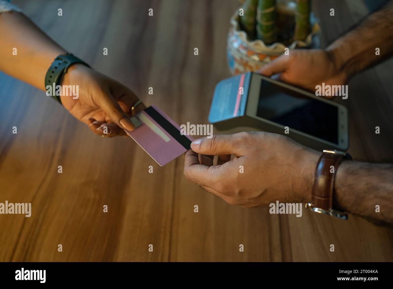 A buyer making a payment through a card machine Stock Photo - Alamy