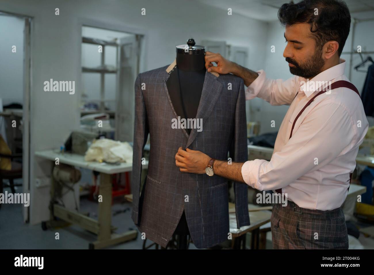 A bespoke tailor checking measurements on a dress form Stock Photo - Alamy