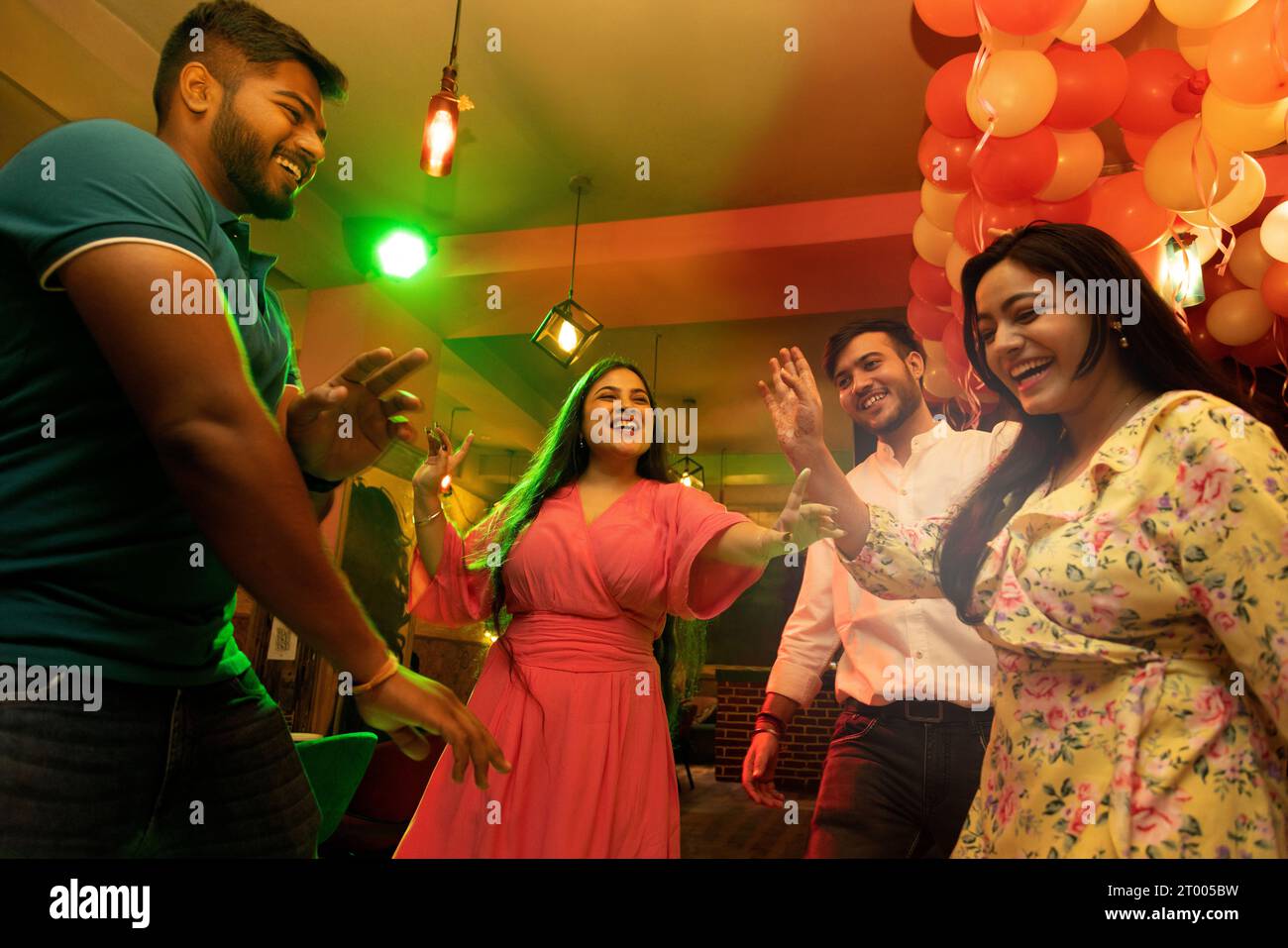 Friends dancing together at restaurant Stock Photo - Alamy
