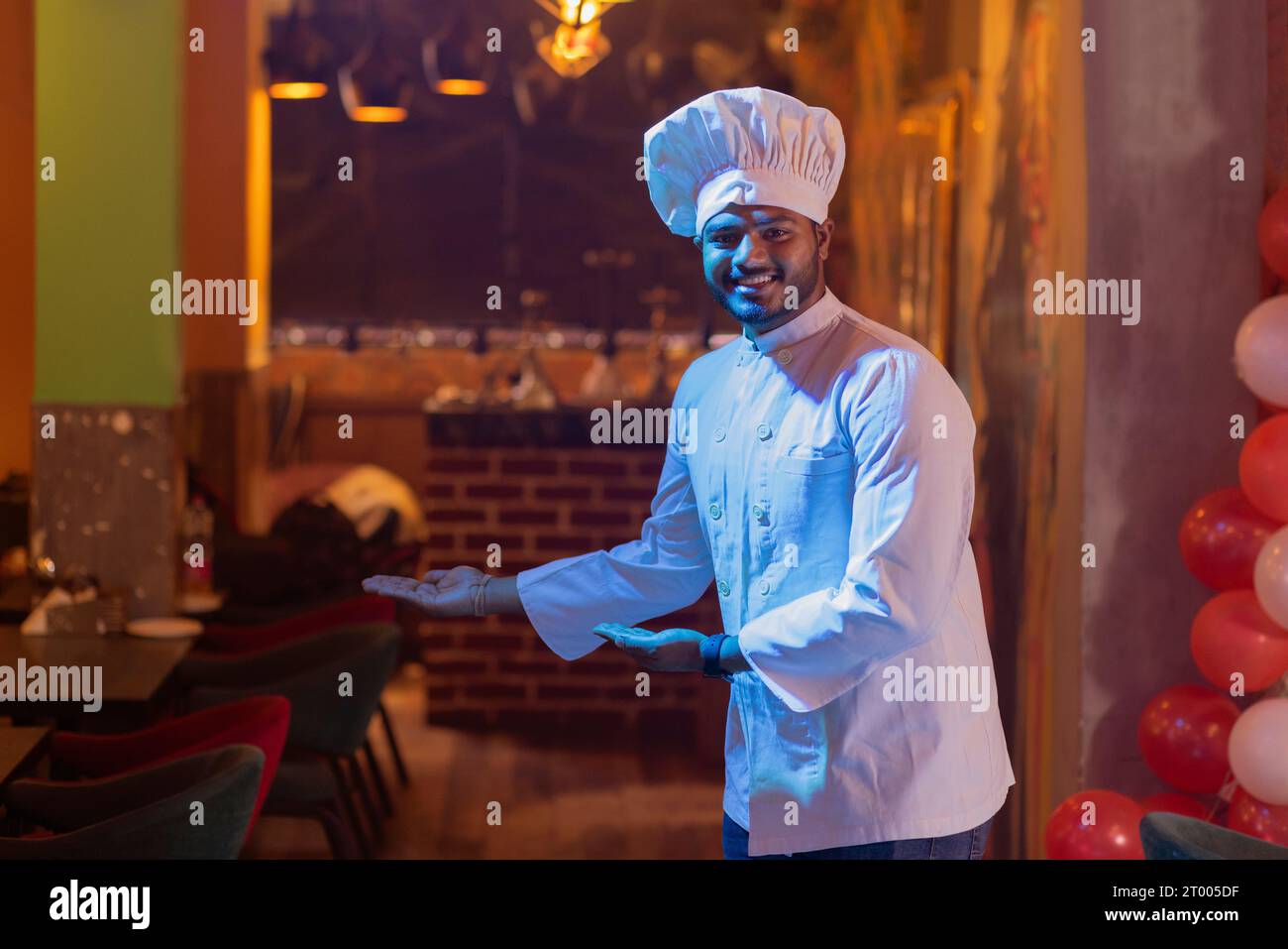 Male chef welcoming guest at restaurant Stock Photo - Alamy