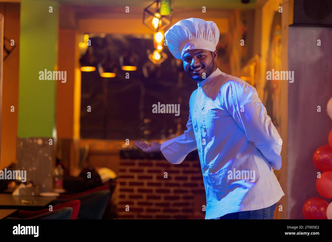 Male chef welcoming guest at restaurant Stock Photo - Alamy