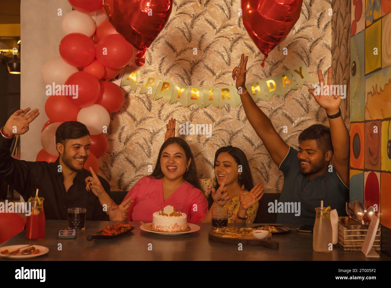 Friends celebrating birthday of their friend at restaurant Stock Photo ...