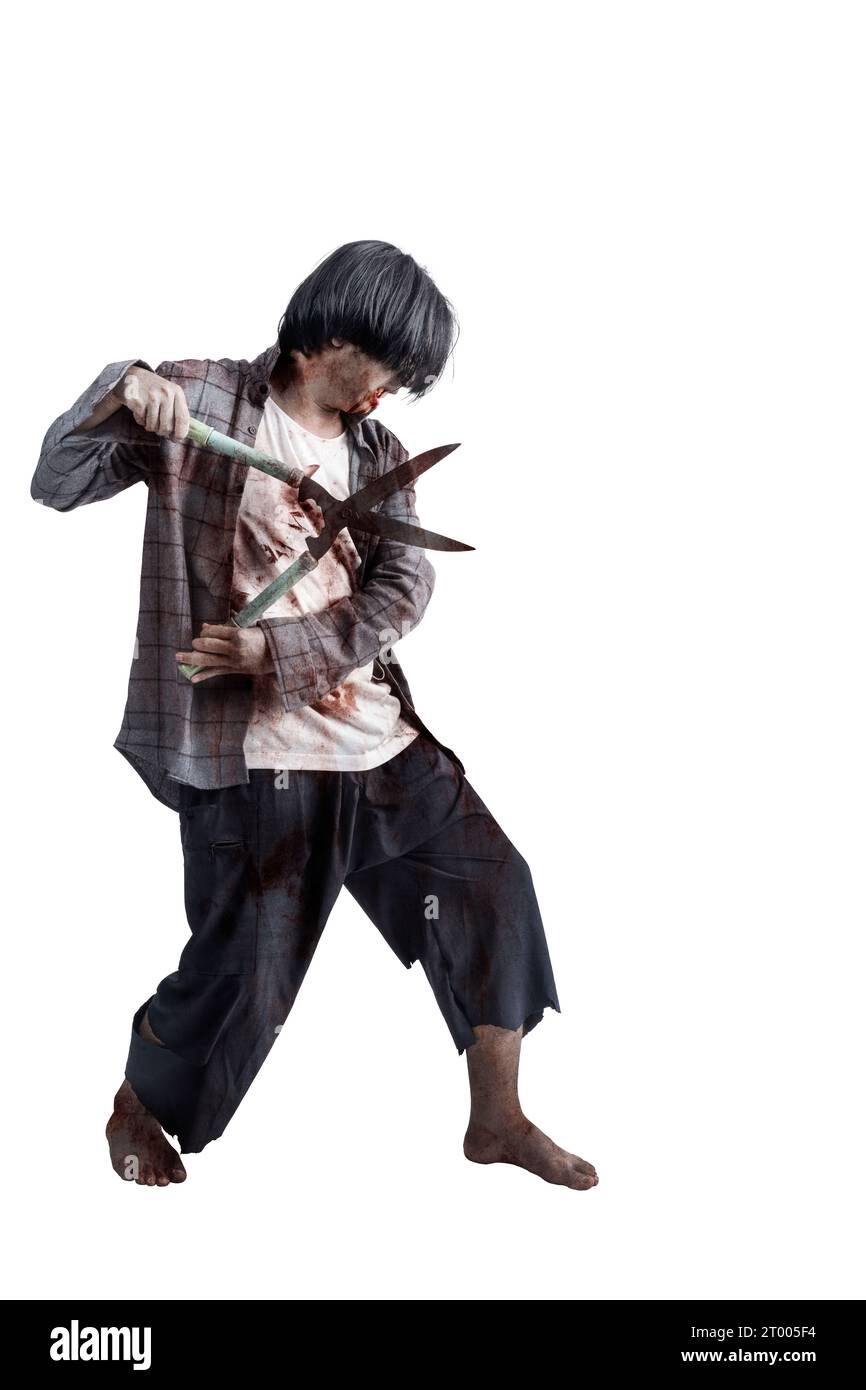 A scary zombie with blood and wounds on his body walking while carrying ...