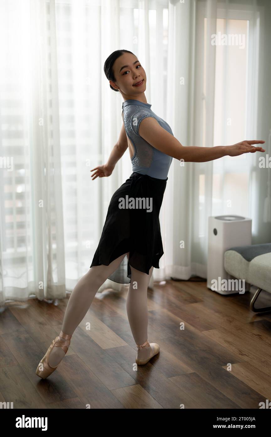 Beautiful woman performing a ballet dance, practicing her dance move at ...
