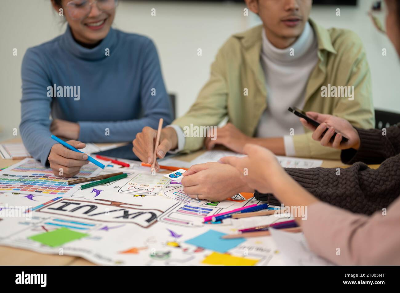 Team of young professional UX/UI designer working together in the meeting room, preparing for ...