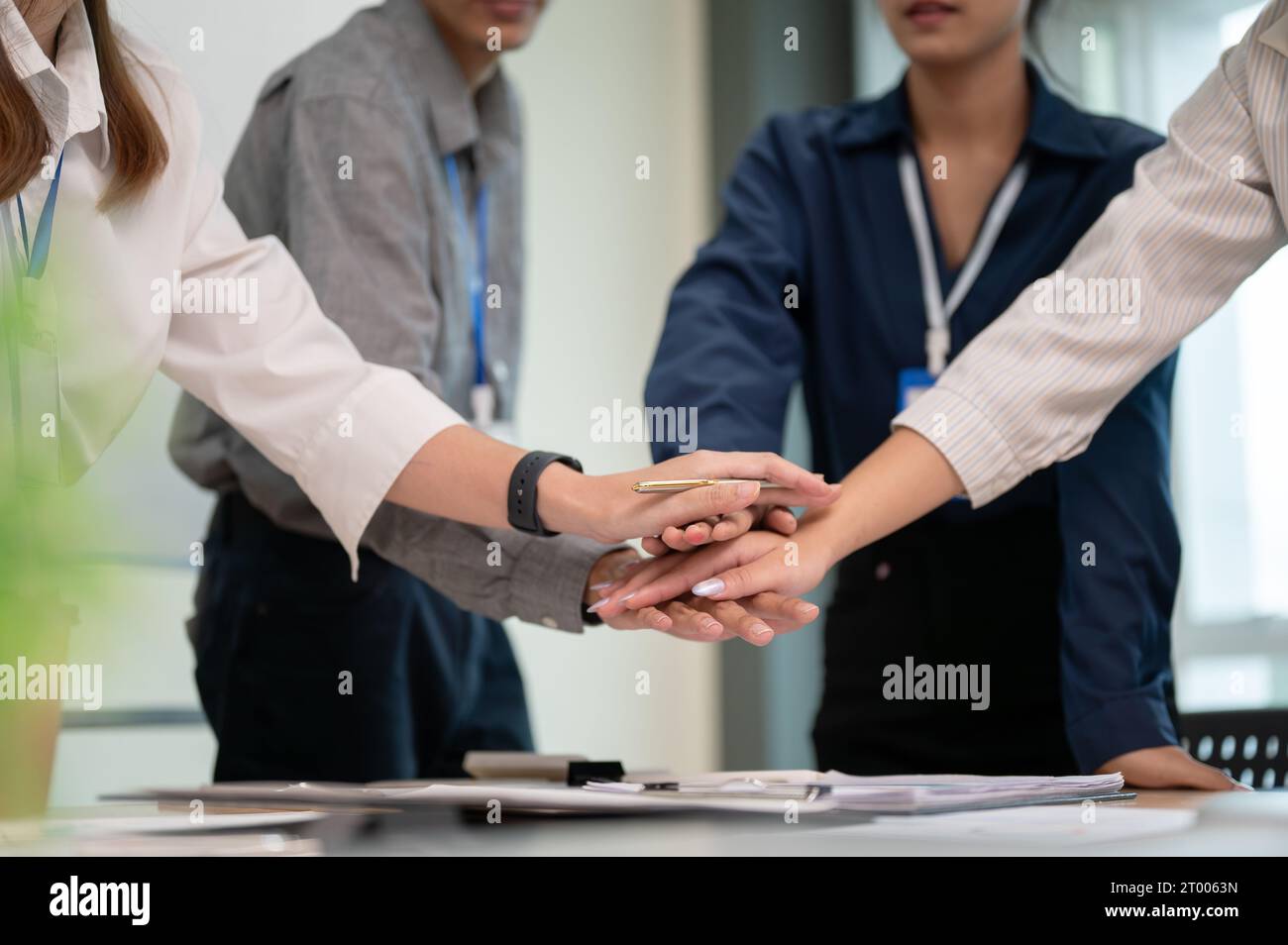 Close up of business people putting their hands together. Business ...