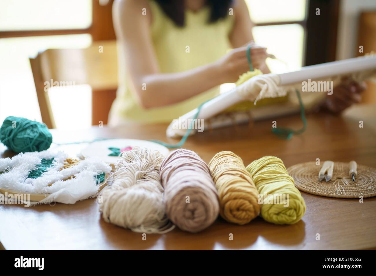 Punch needle. Asian Woman making handmade Hobby knitting in studio ...