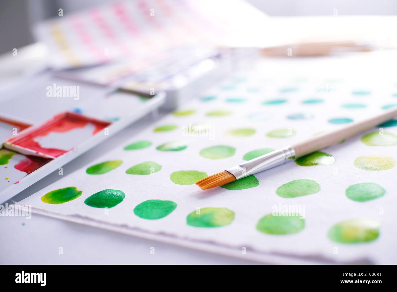 Watercolor paints and brushes workplace artist with artistic tools for ...