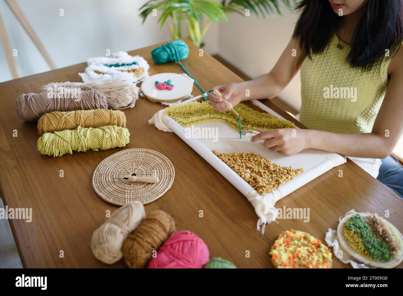 Punch needle. Asian Woman making handmade Hobby knitting in studio ...