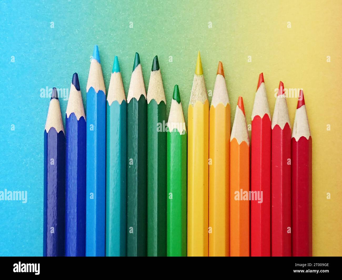 colorful pens arranged in the colors of the rainbow on colorful paper ...