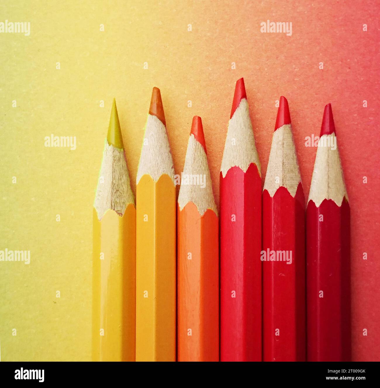 colorful pens arranged in the colors of the rainbow on colorful paper ...