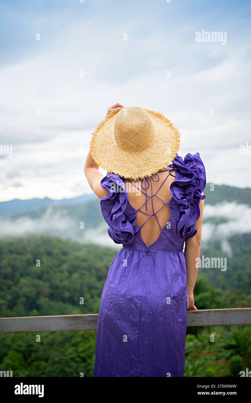 Carefree happy woman in morning of nature cliff mountain. Woman travel ...