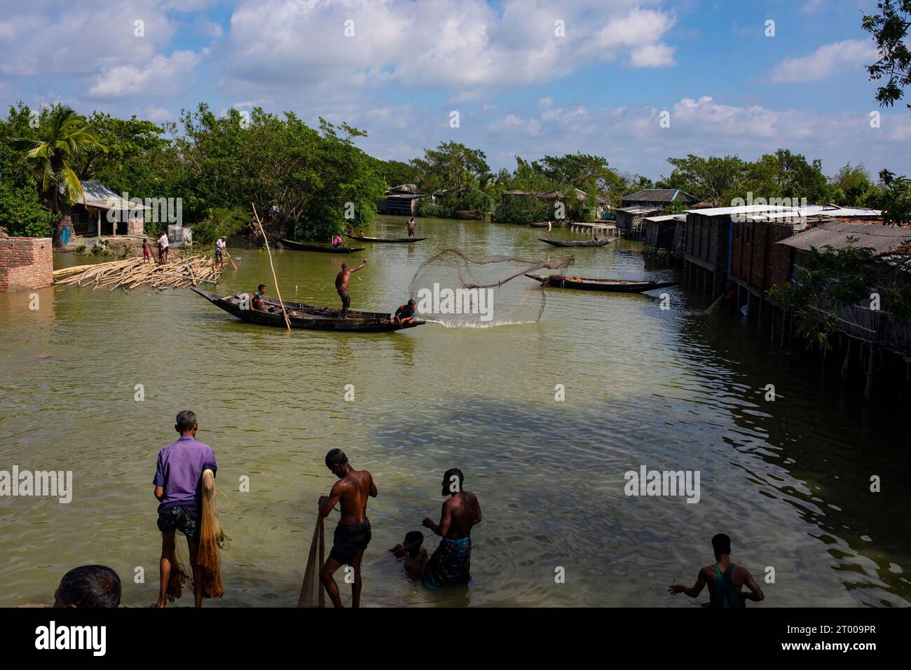 Villagers catching fishes in flood water at Gabura union in Shyamnagar ...
