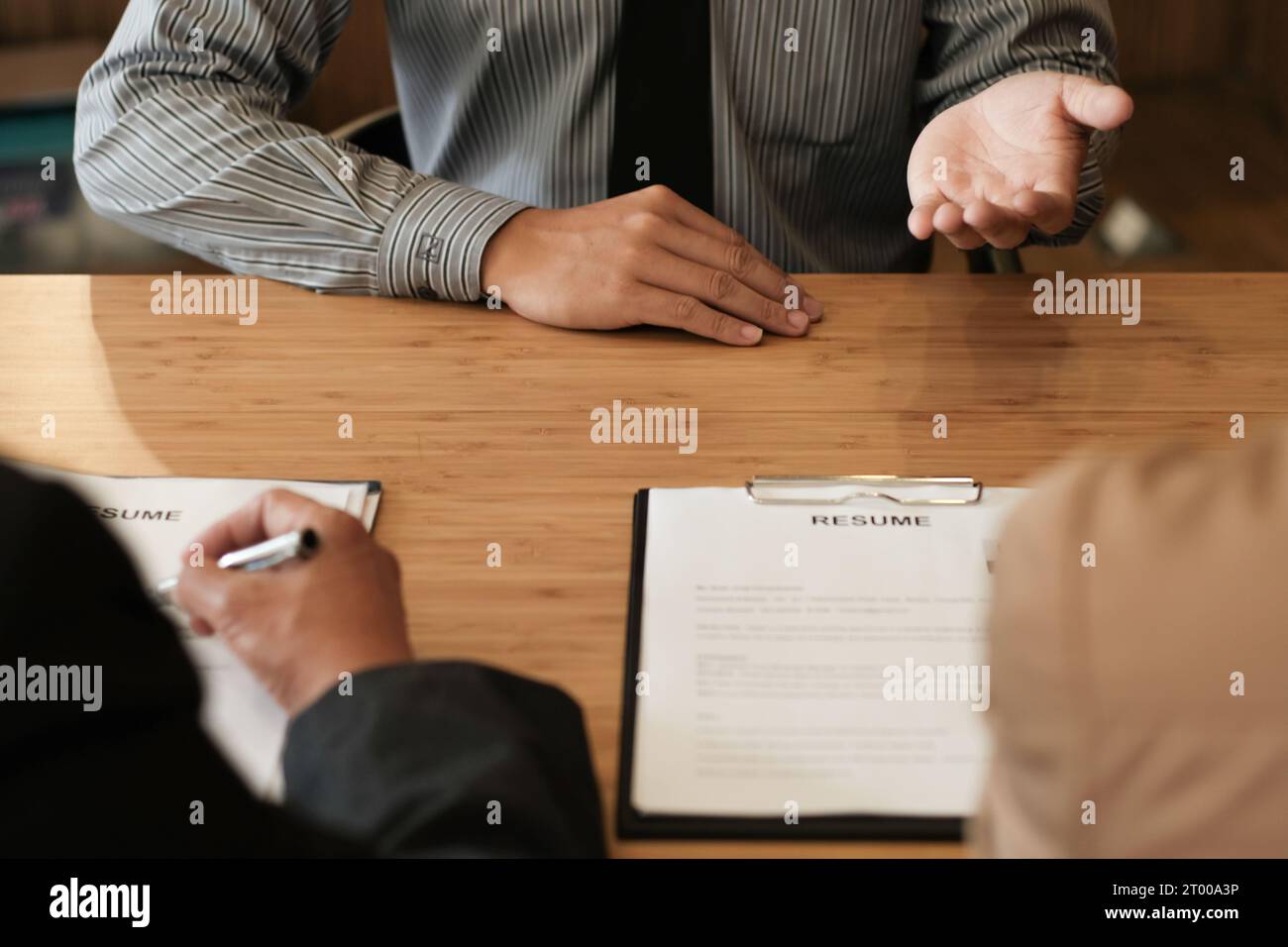 Examiner reading a resume during job interview at office Business and ...