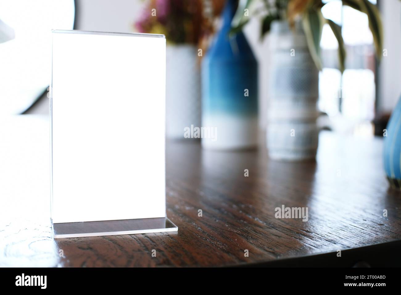 Menu frame standing on wood table in Bar restaurant cafe. space for ...
