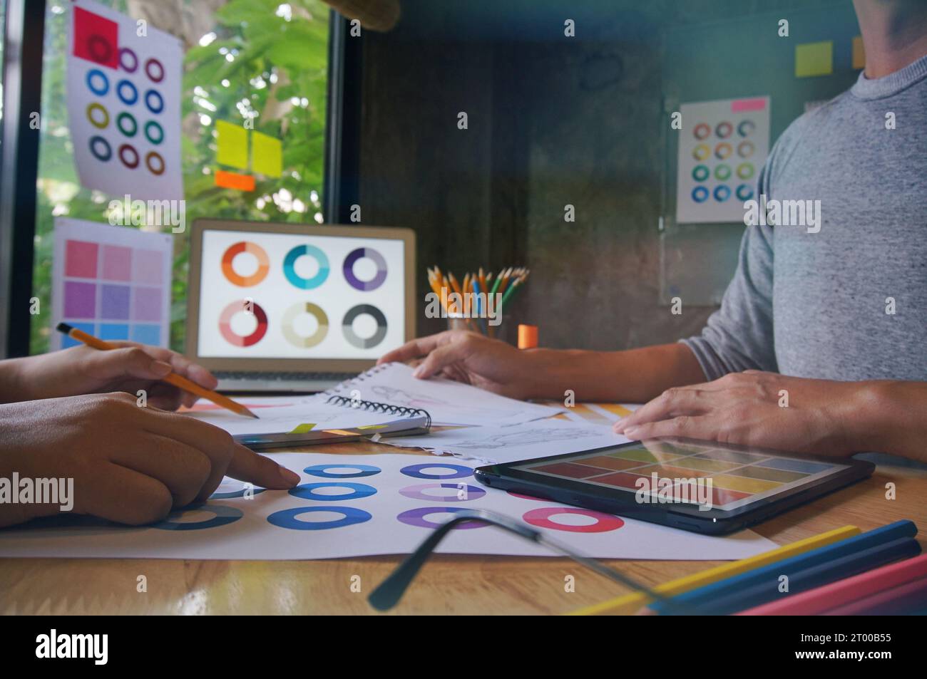 Stylish Fashion Designer work as sketch of new collection in atelier ...