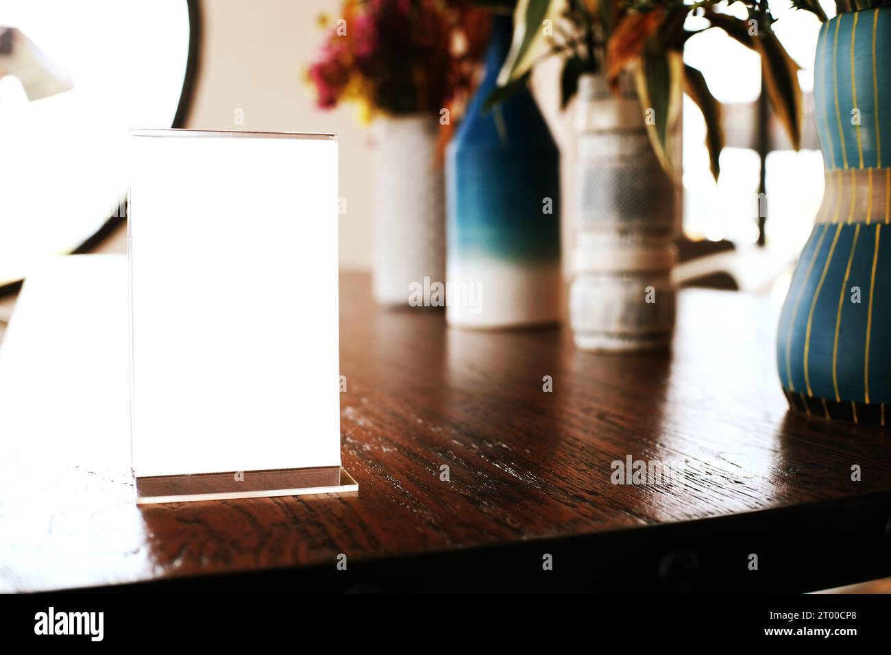 Menu frame standing on wood table in Bar restaurant cafe. space for ...