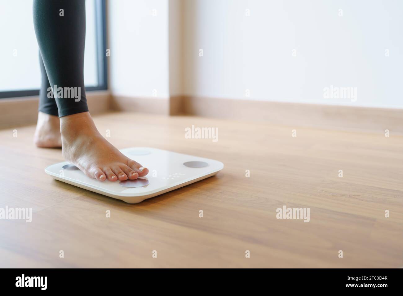 Lose weight. Fat diet and scale feet standing on electronic scales for ...