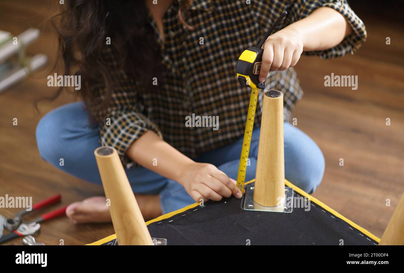Asian Woman self repairs furniture renovation using equipment to diy ...