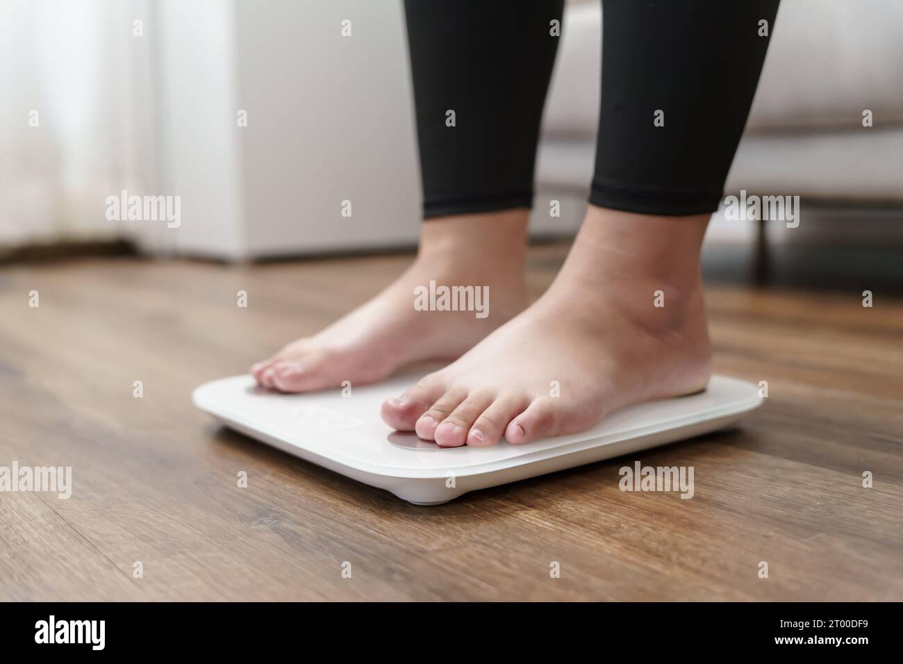 Big feet on scales hi-res stock photography and images - Alamy