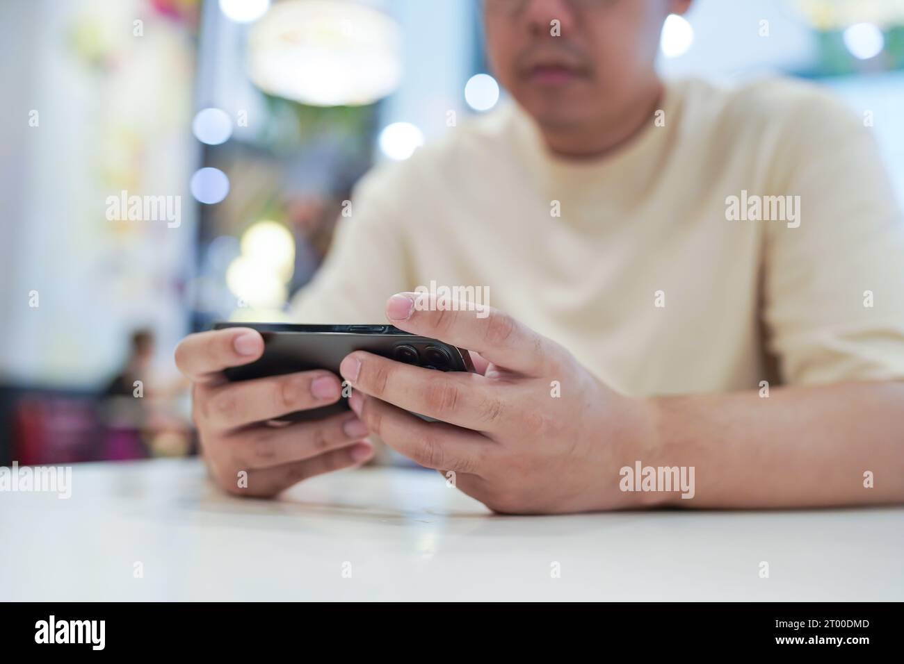 Man playing game on mobile phone. gamer boy playing video games holding ...