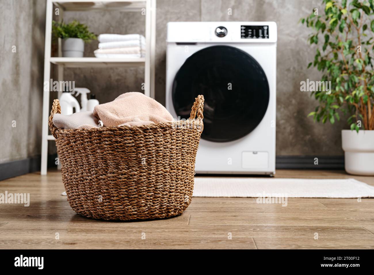 Washing machine in a gray modern laundry room Stock Photo - Alamy