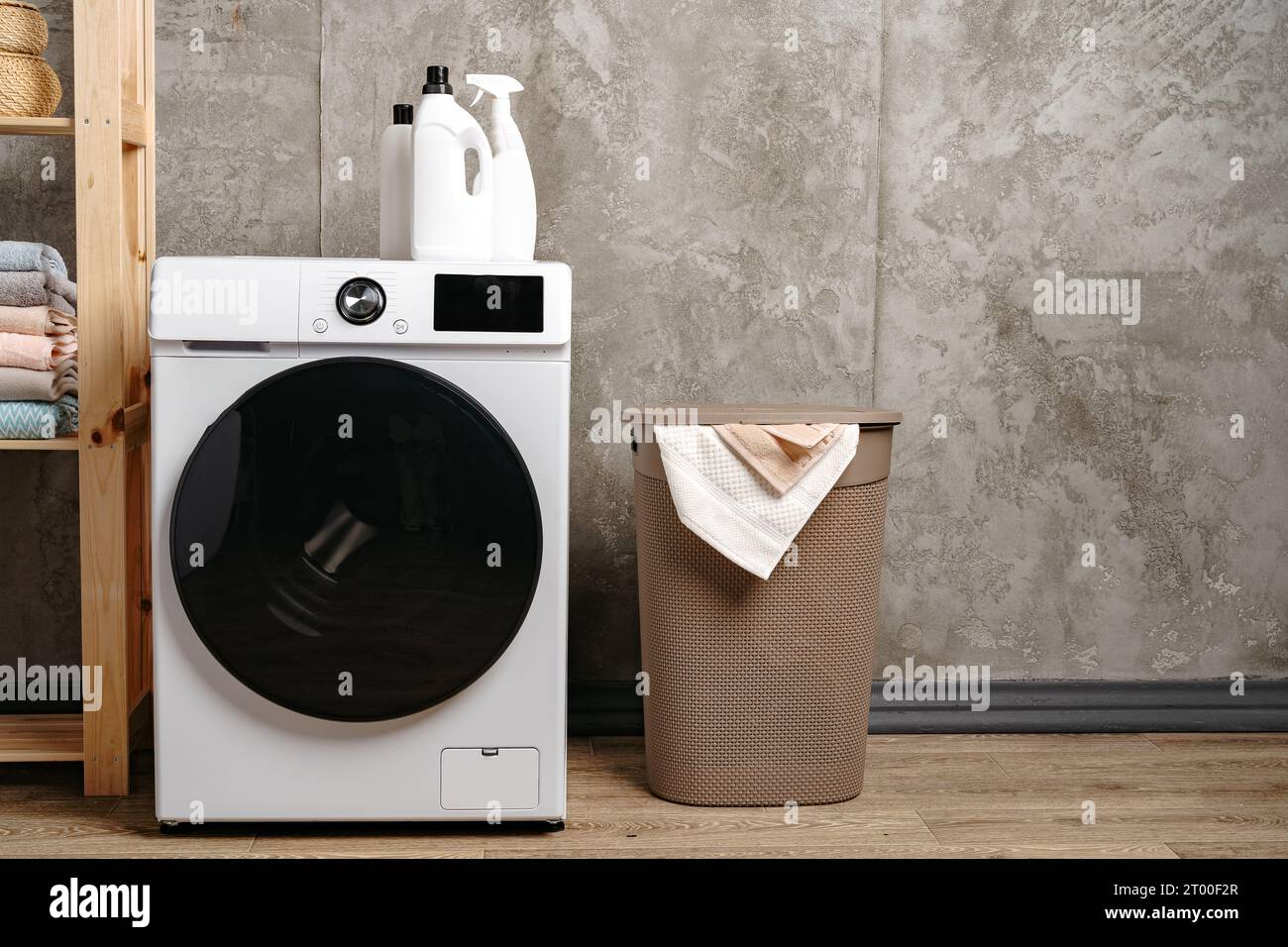 Washing machine in a gray modern laundry room Stock Photo - Alamy