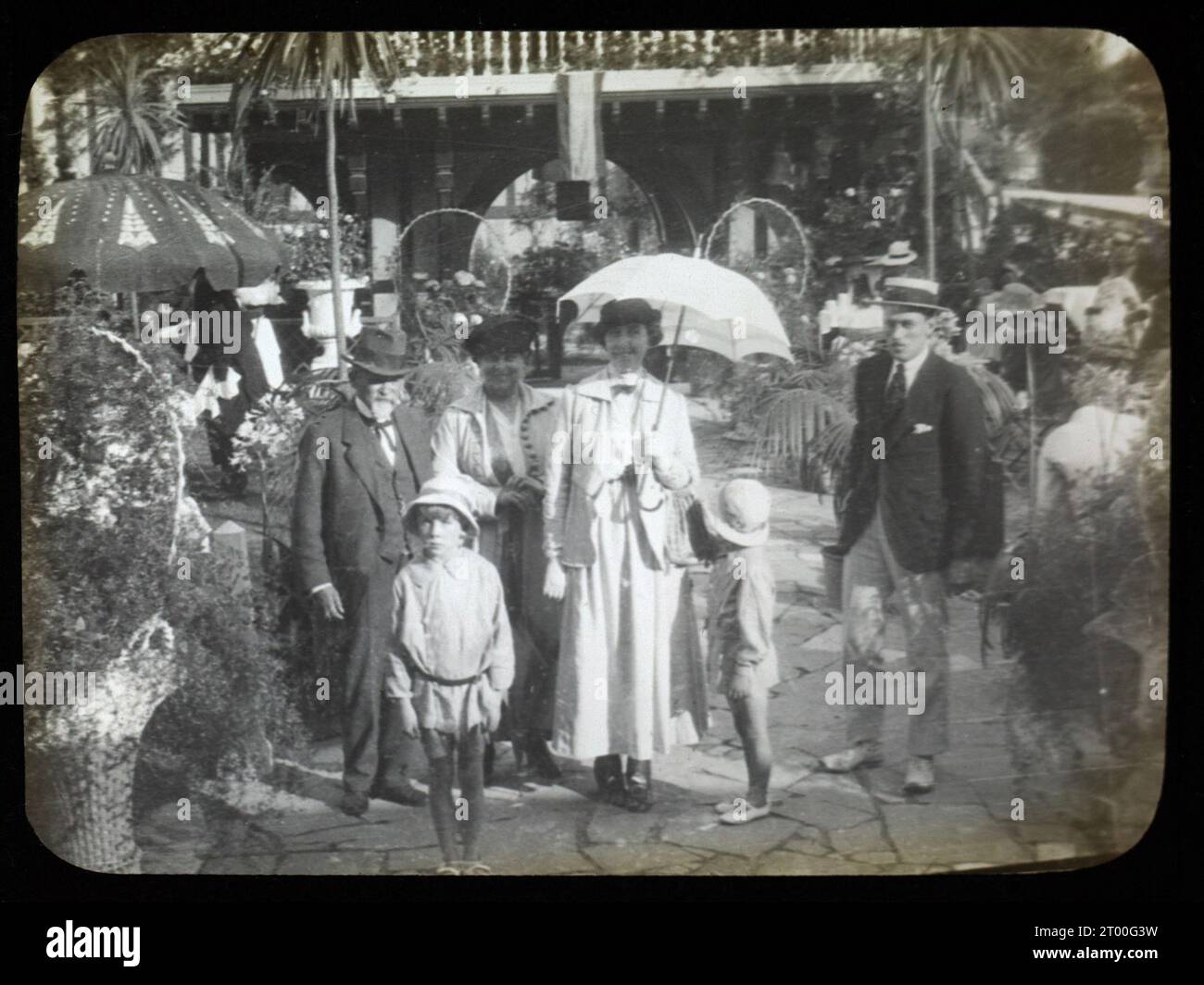 Family group standing in pleasure gardens at Karsino of Fred Karno ...