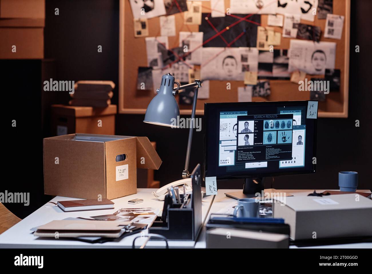 Image of detectives office with computer on desk and evidence board in ...