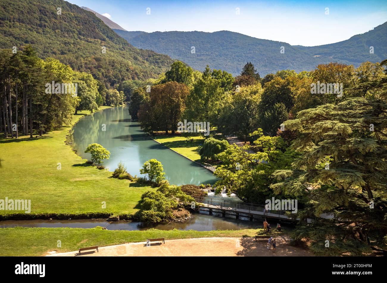 A view across the lake and gardens towards wooded hills from the ...