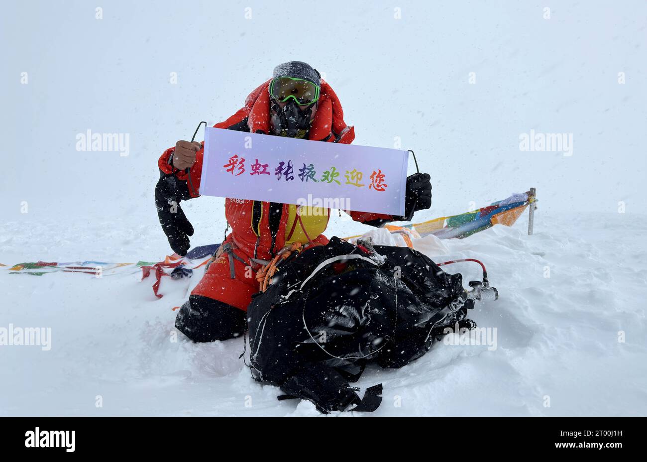 SHIGATSE, CHINA - OCTOBER 1, 2023 - Ma Xiao displays the flag on top of ...