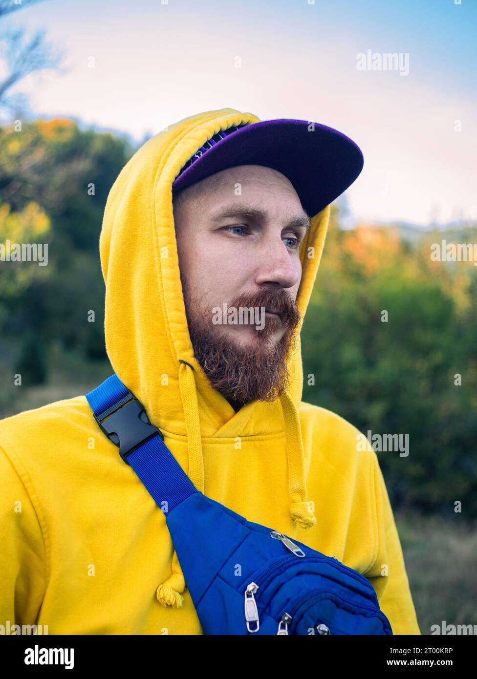 Red bearded millennial man with mustache in yellow hoody smiling ...